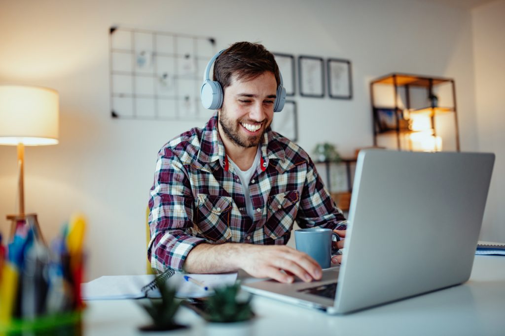 Entrepreneur working from home on laptop, attending online business ...